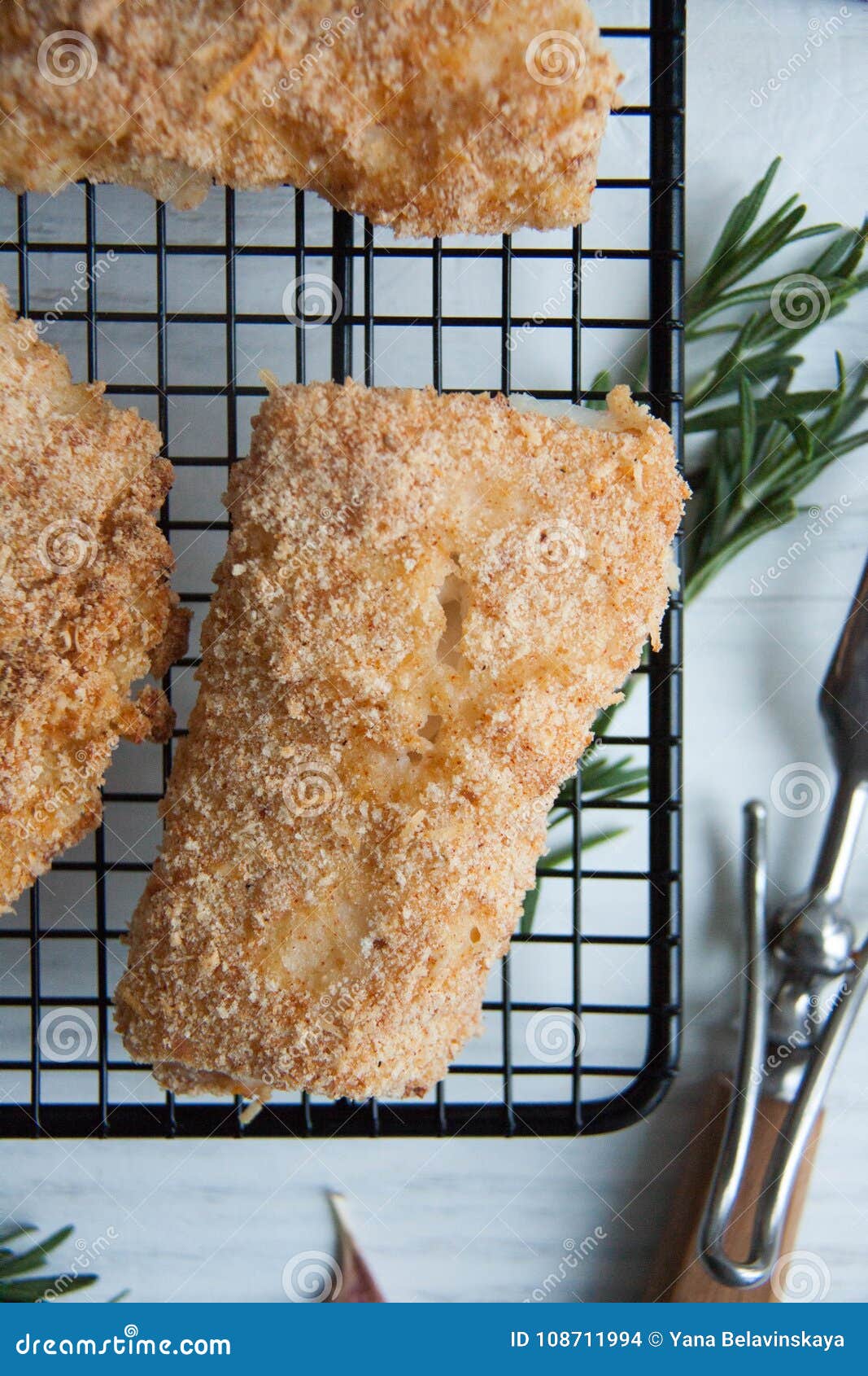 Cod Fish in Breadcrumbs on a Black Wire Rack Stock Photo - Image of ...