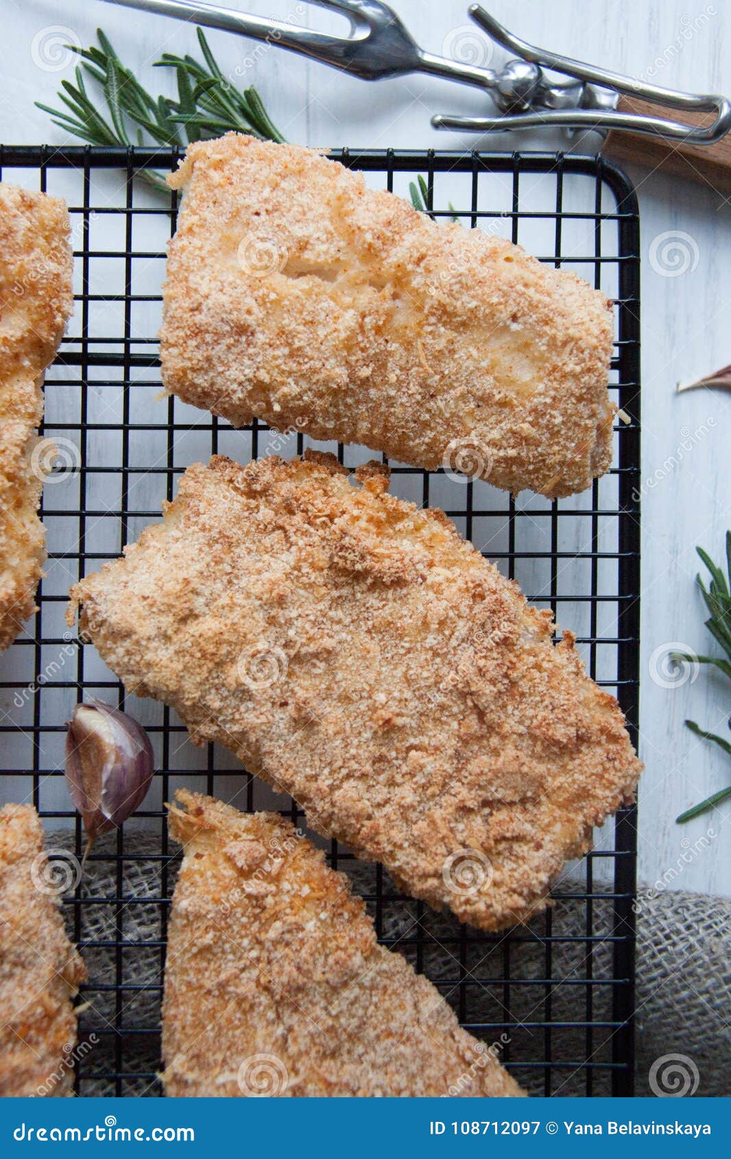 Cod Fish in Breadcrumbs on a Black Wire Rack Stock Image - Image of ...