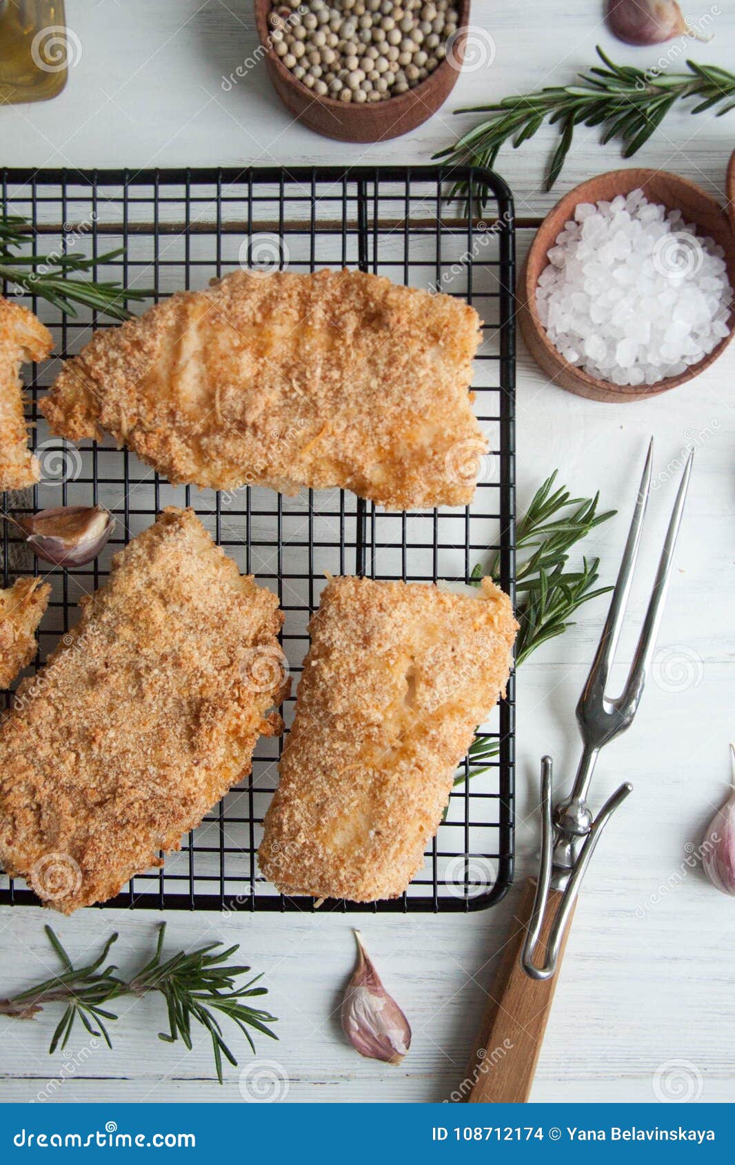 Cod Fish in Breadcrumbs on a Black Wire Rack Stock Photo - Image of ...