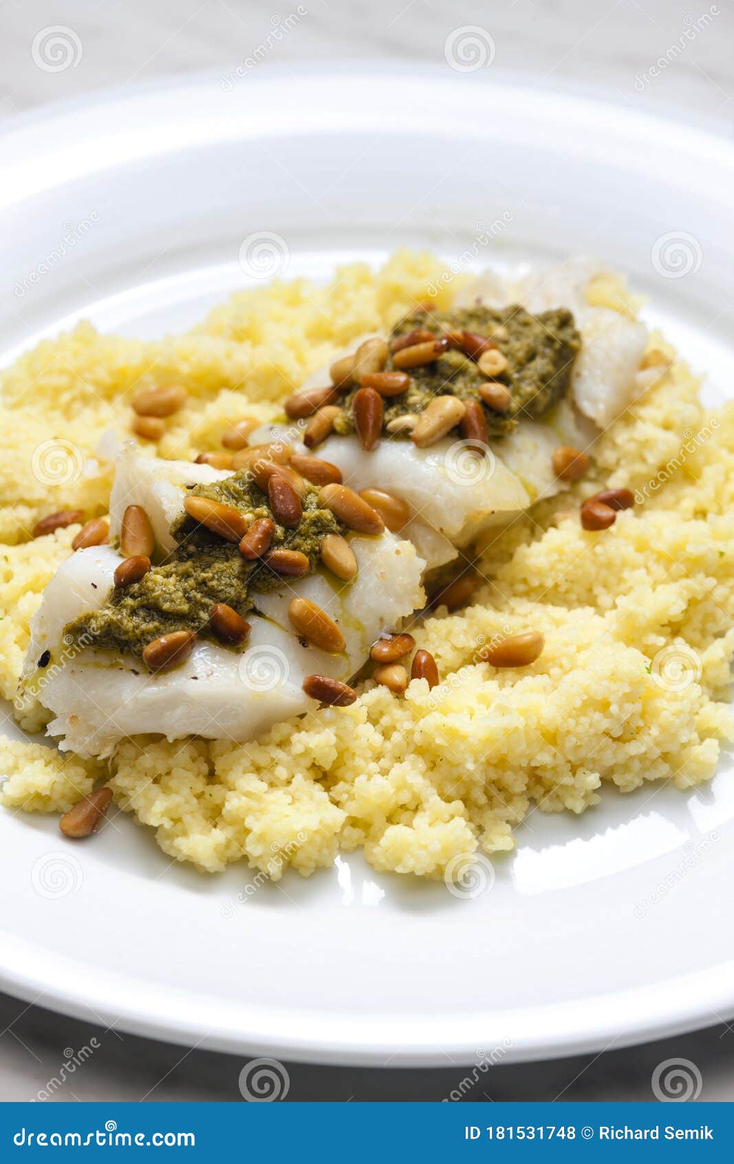 Cod with Green Pesto and Pine Seeds with Couscous Stock Photo - Image ...