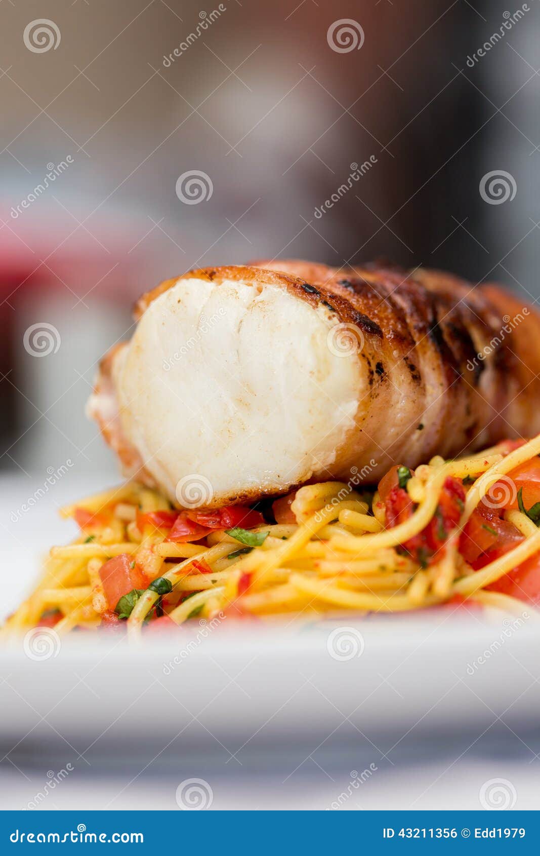Cod wrapped in bacon stock photo. Image of basil, tomato - 43211356