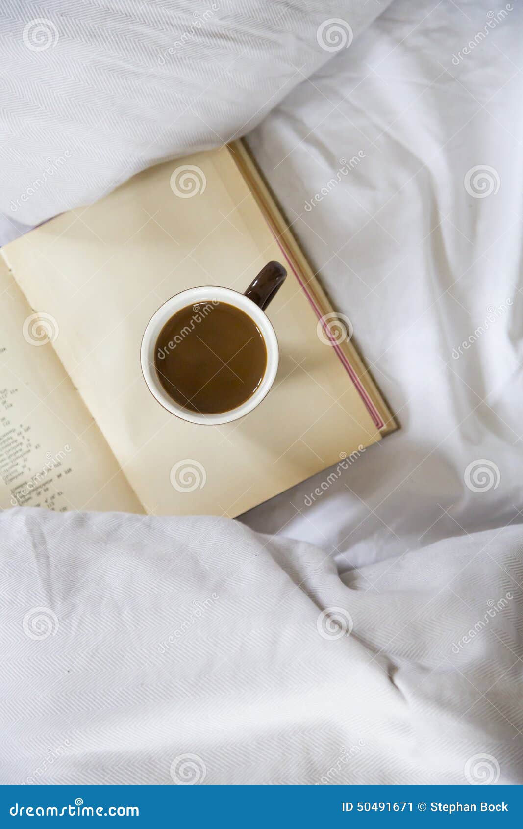 Coffee cup and book on bed stock image. Image of crockery - 50491671