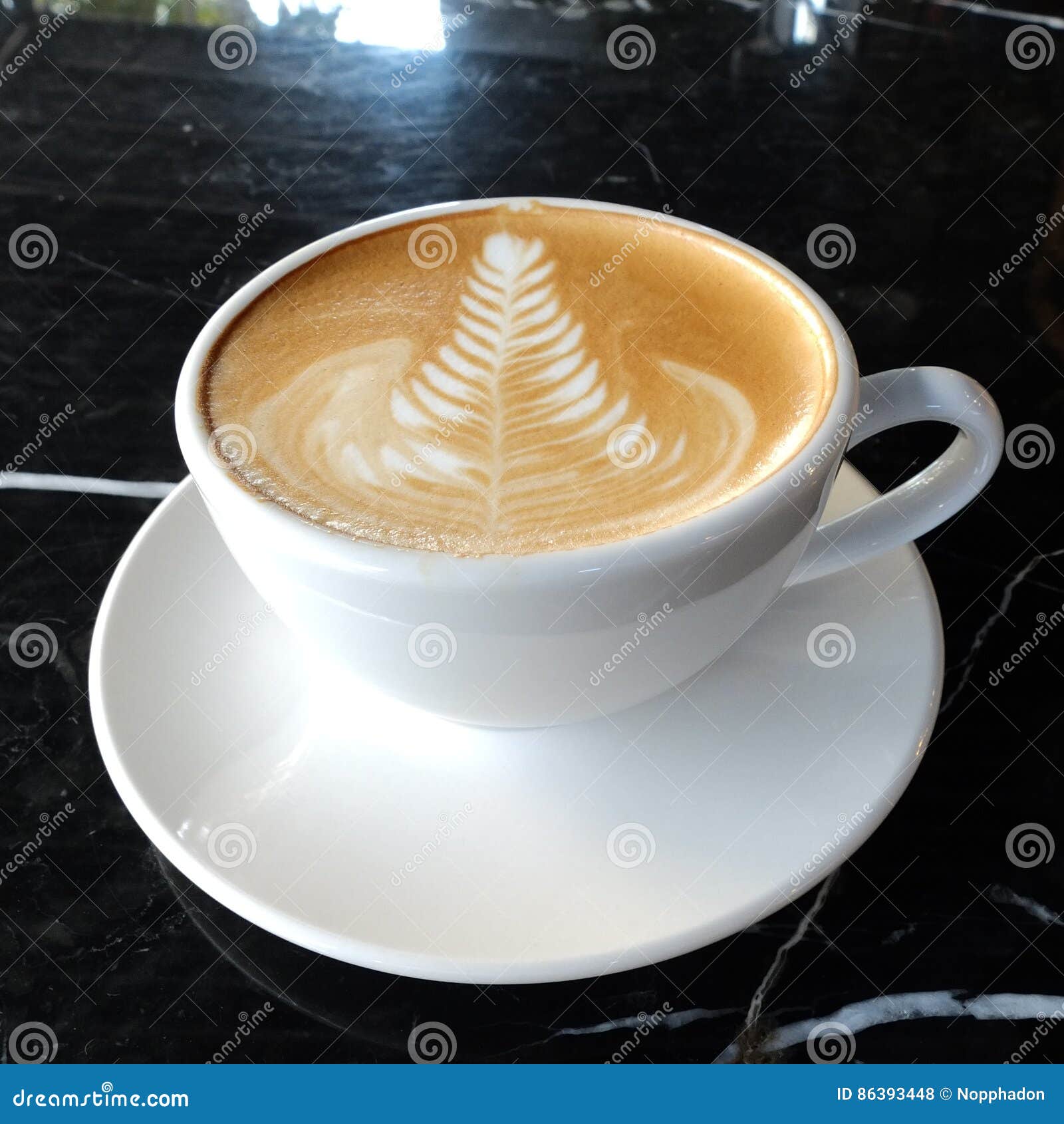 Coffee Cup with Latte Art Rosetta Pattern on the Black Marble Ta Stock ...