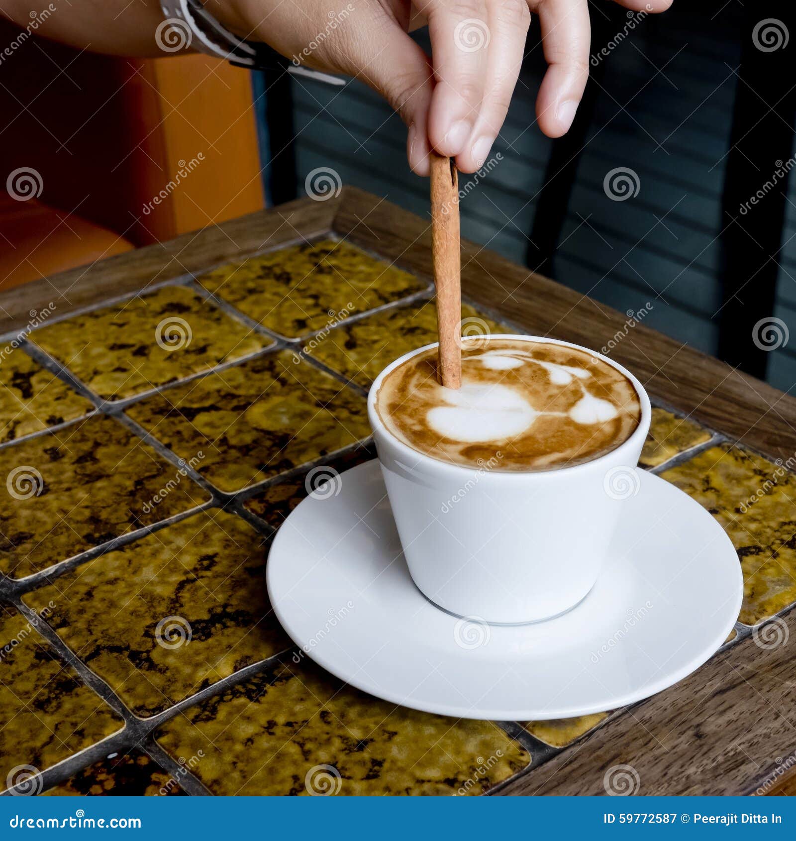 A Coffee Cup Latte Being Stirred by Cinnamon Sticks. Stock Image ...