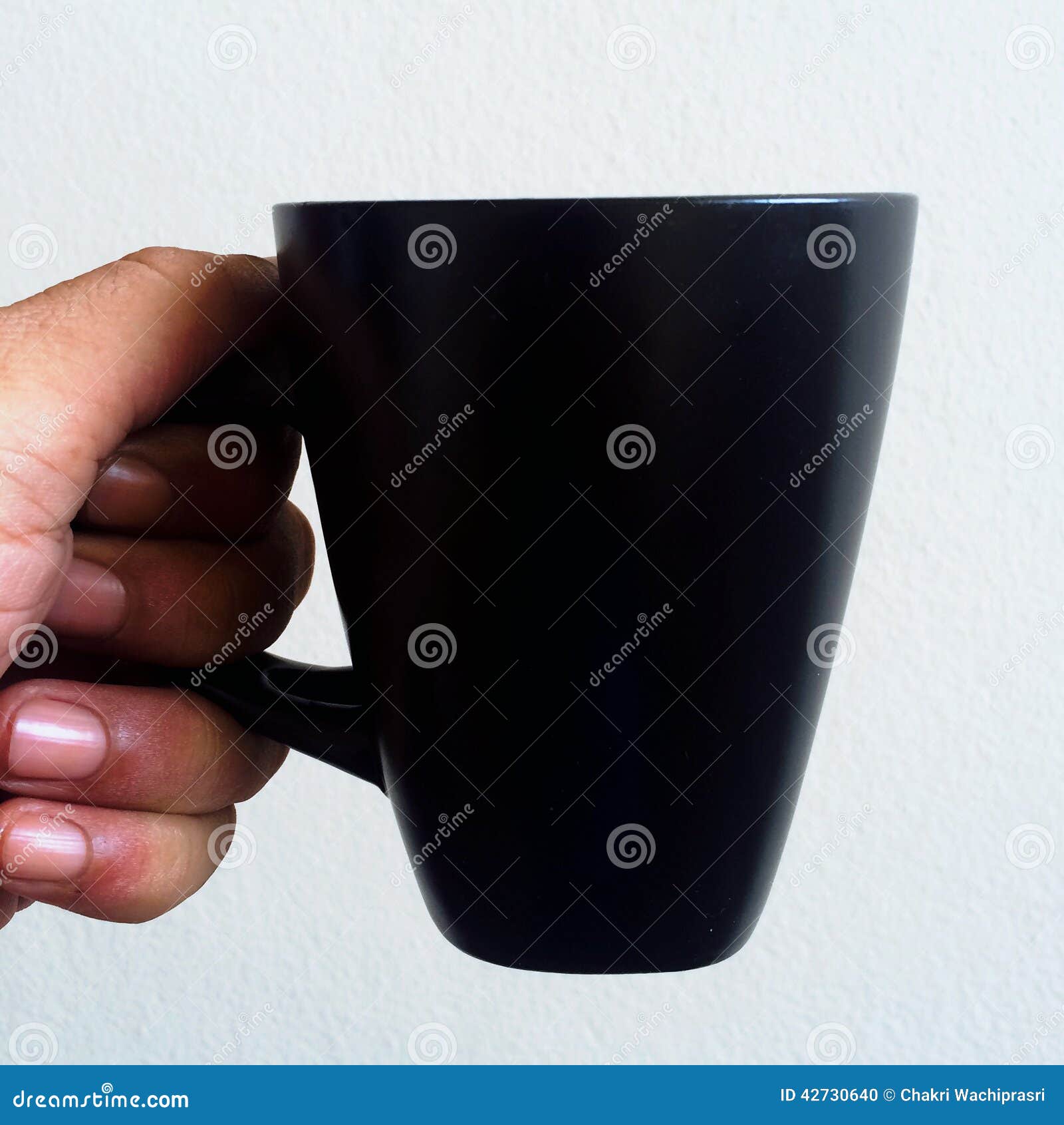 Black coffee mug in hand stock photo. Image of drink - 42730640