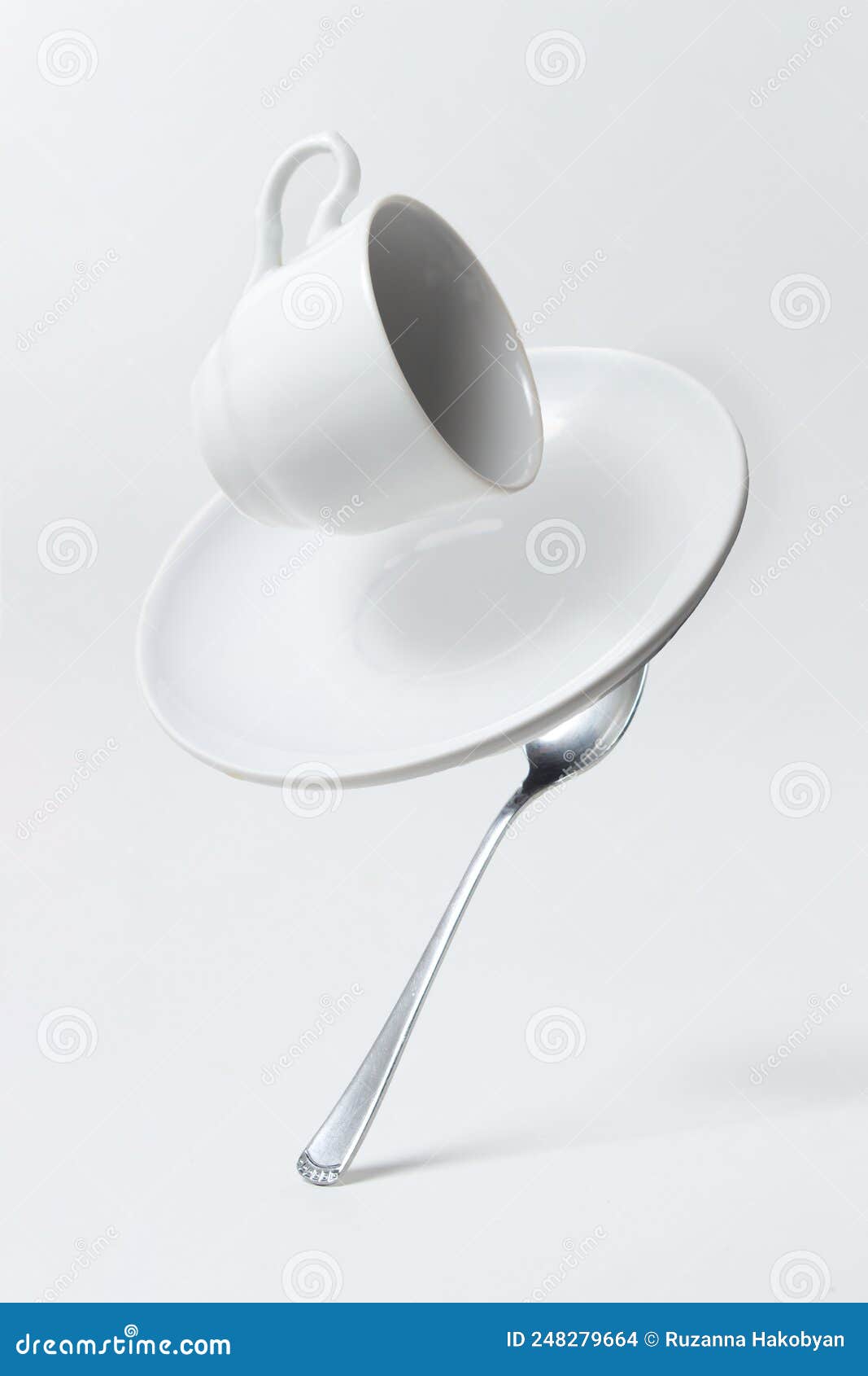 Coffee Cup with Saucer Floating Tilted in the Air on a White Background ...