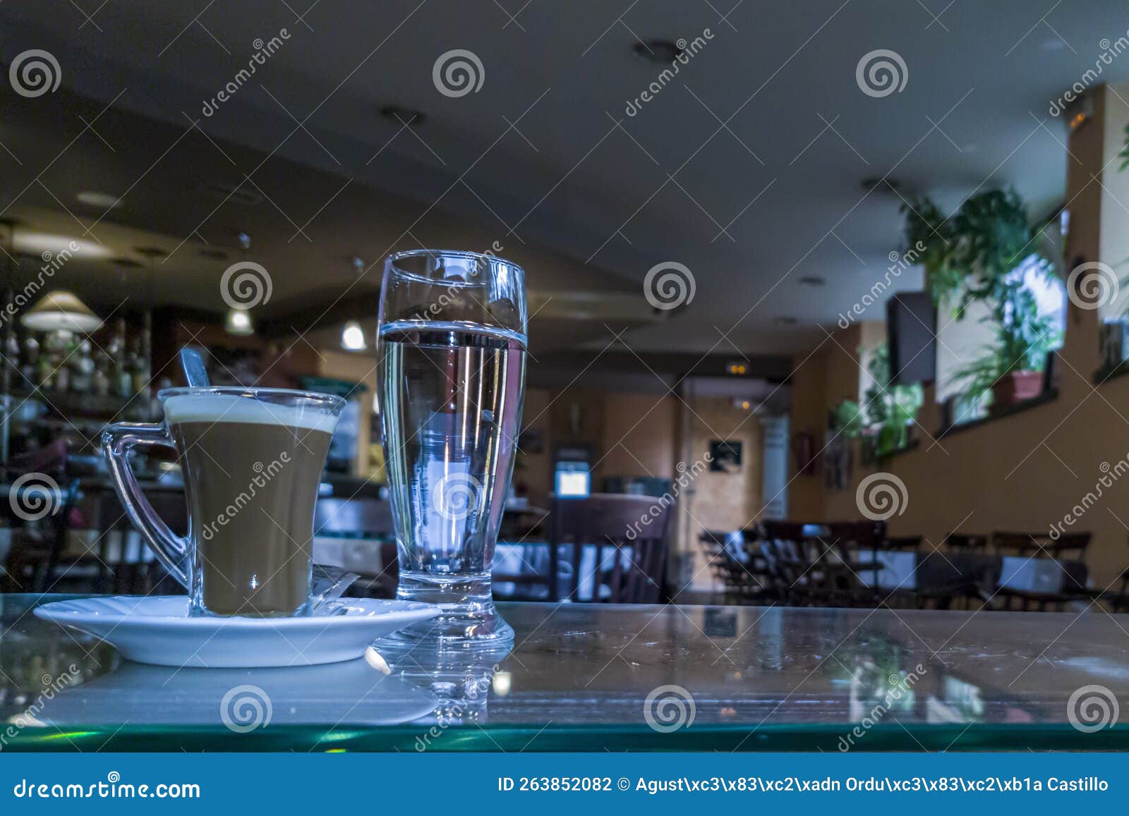 Coffee Cut with Milk, Along with a Glass of Fresh Water. Stock Photo ...