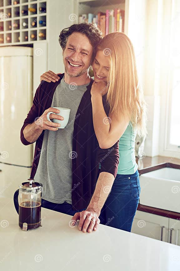 Coffee is a Hug in a Mug. an Affectionate Couple in the Kitchen. Stock ...