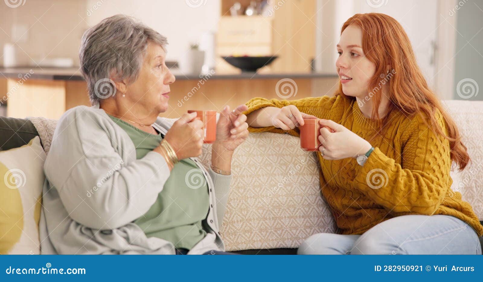Coffee Mother With Daughter Talking And On Sofa In Living Room Of