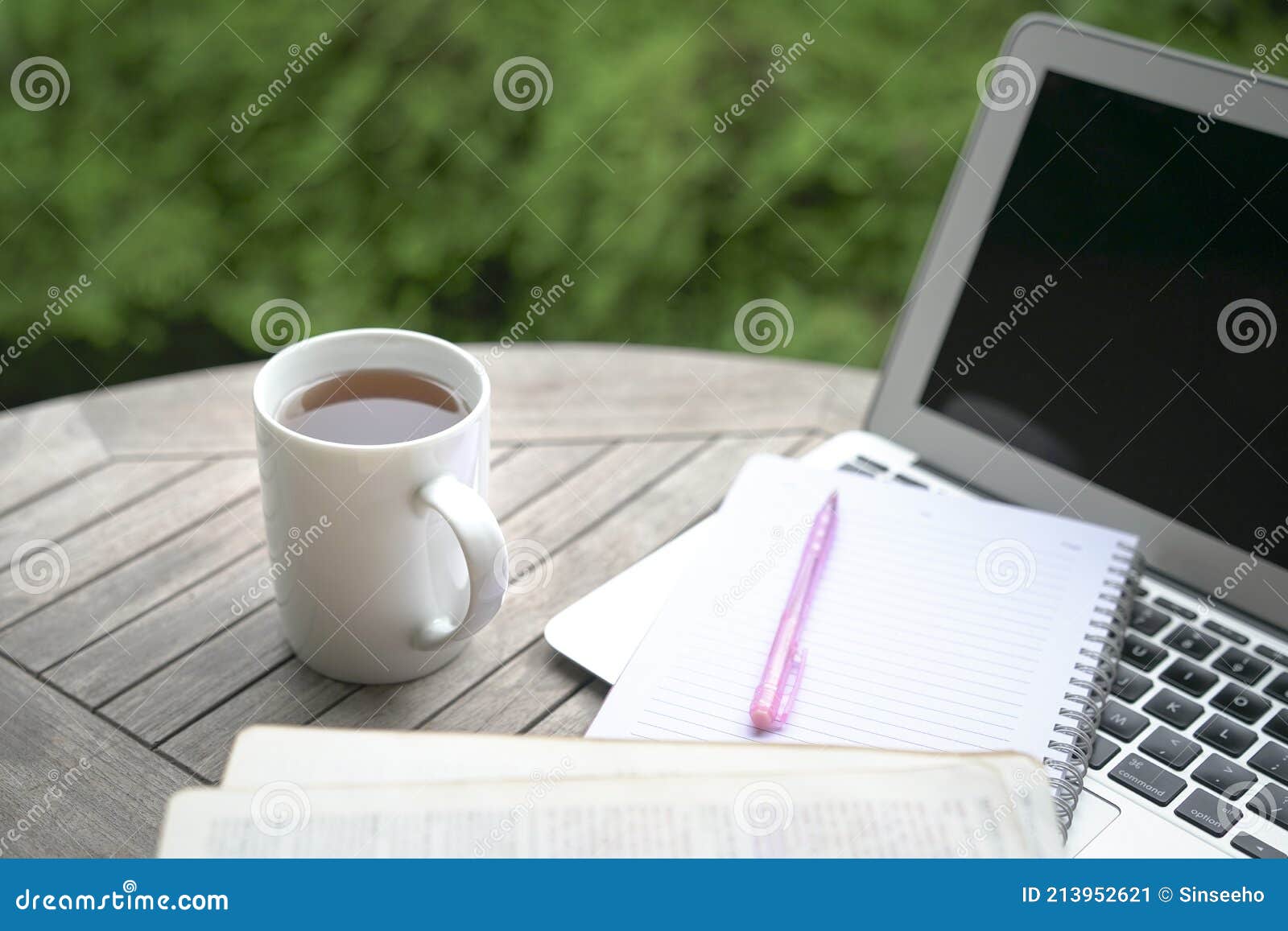 Coffee, Notepad, Book, Pen and Computer Laptop on Table with Green ...