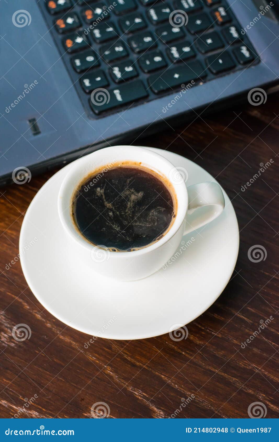 Coffee in a White Cup and a Laptop on the Background on a Brown Wooden ...