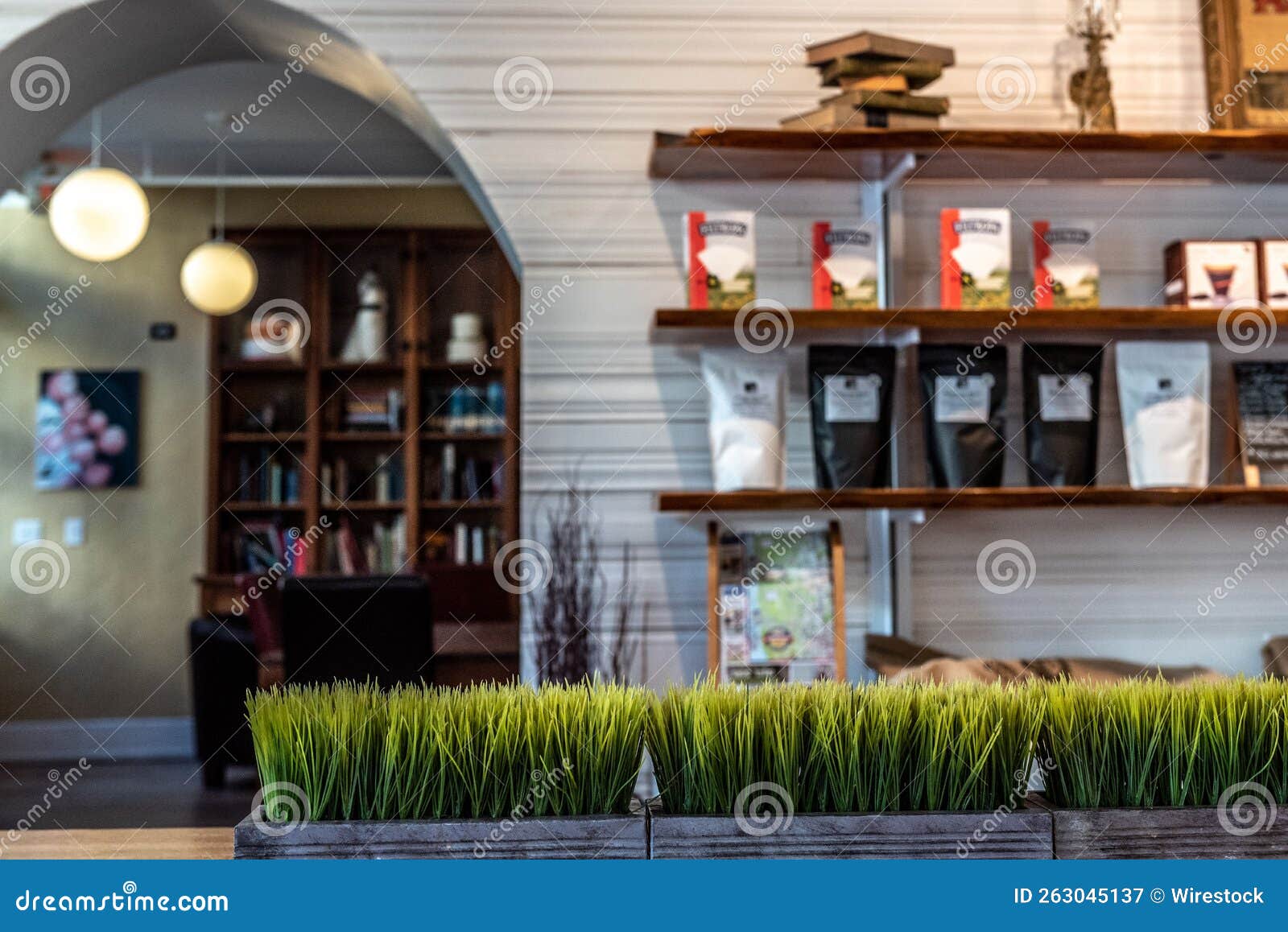 Coffeeshop Scene with an Arched Wall and Shelves of Wheat Grass in the ...