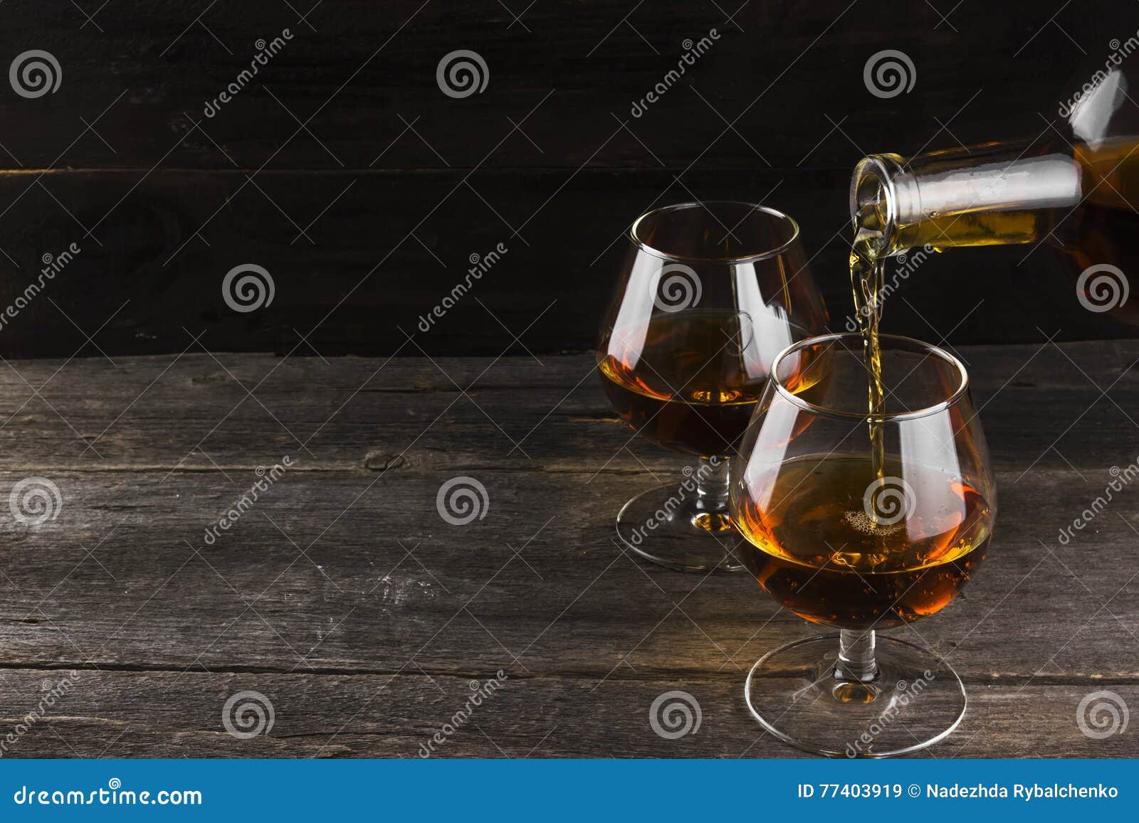 Cognac In Two Glasses On A Dark Wooden Background Stock Image - Image ...