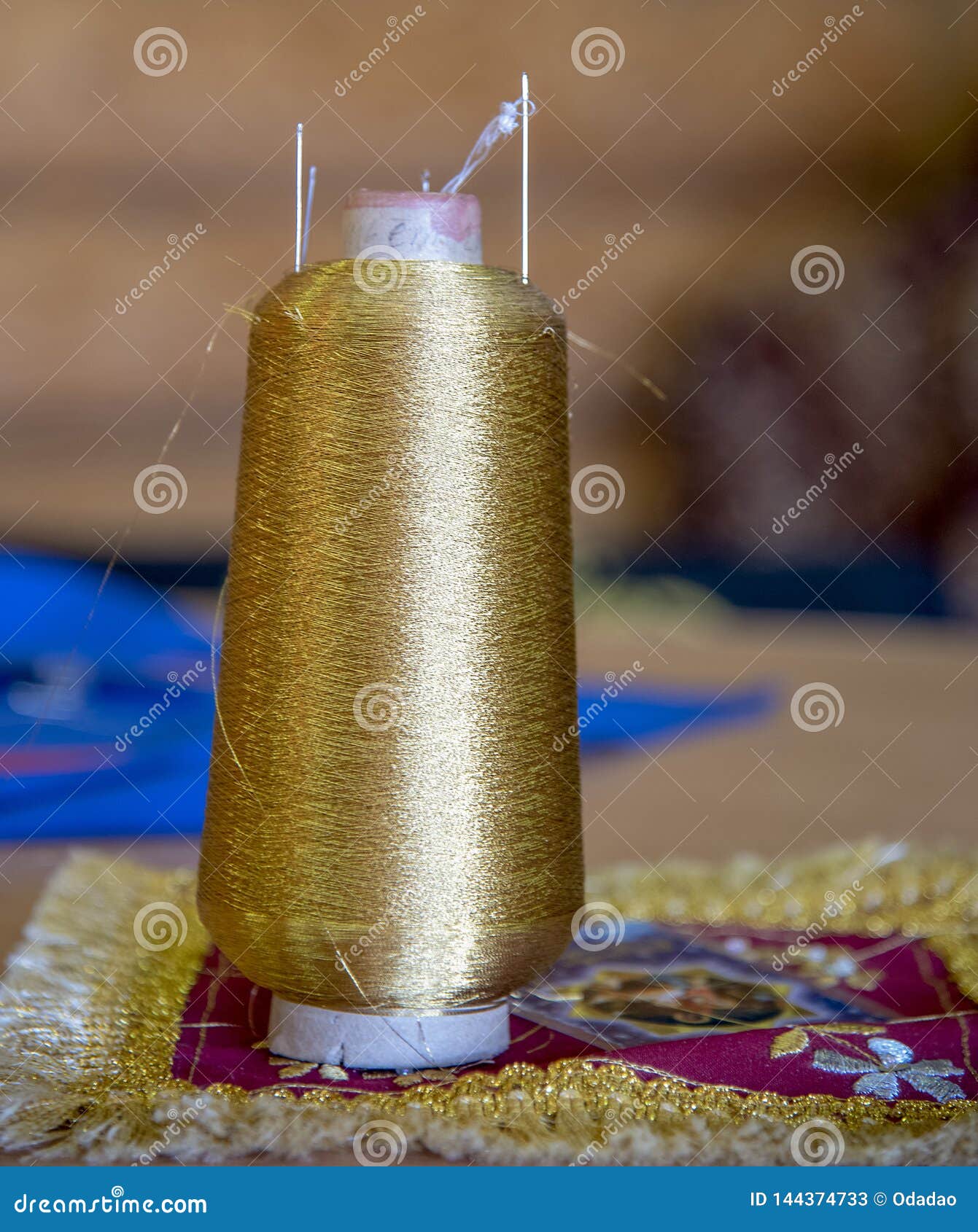 A Coil of Gold Thread Stands on the Table. the Coil is Inserted the ...