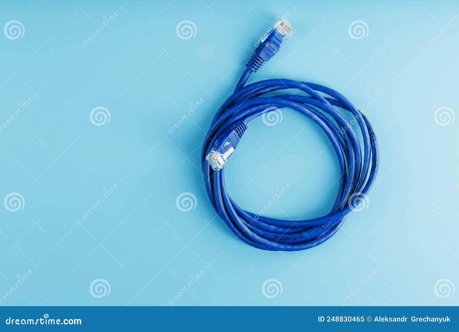A Coil of an Internet Network Cable for Data Transmission on a Blue ...