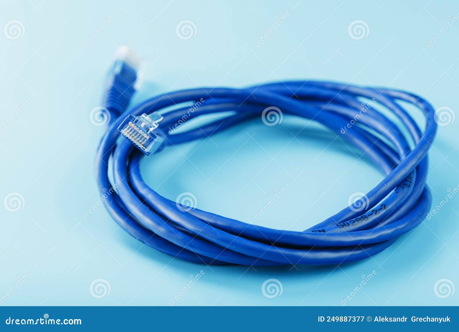 A Coil of an Internet Network Cable for Data Transmission on a Blue ...