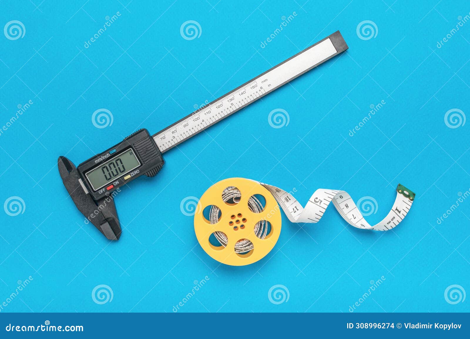 A Coil with a Measuring Tape and a Caliper on a Blue Background Stock ...