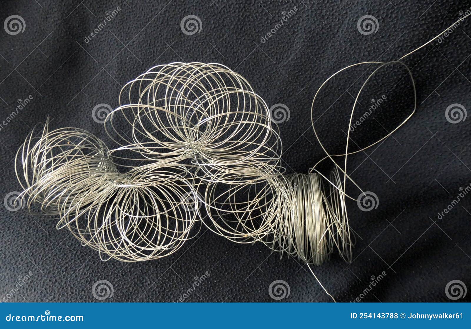 Coil of Thin Steel Wire on Cloth Background Stock Photo - Image of line ...