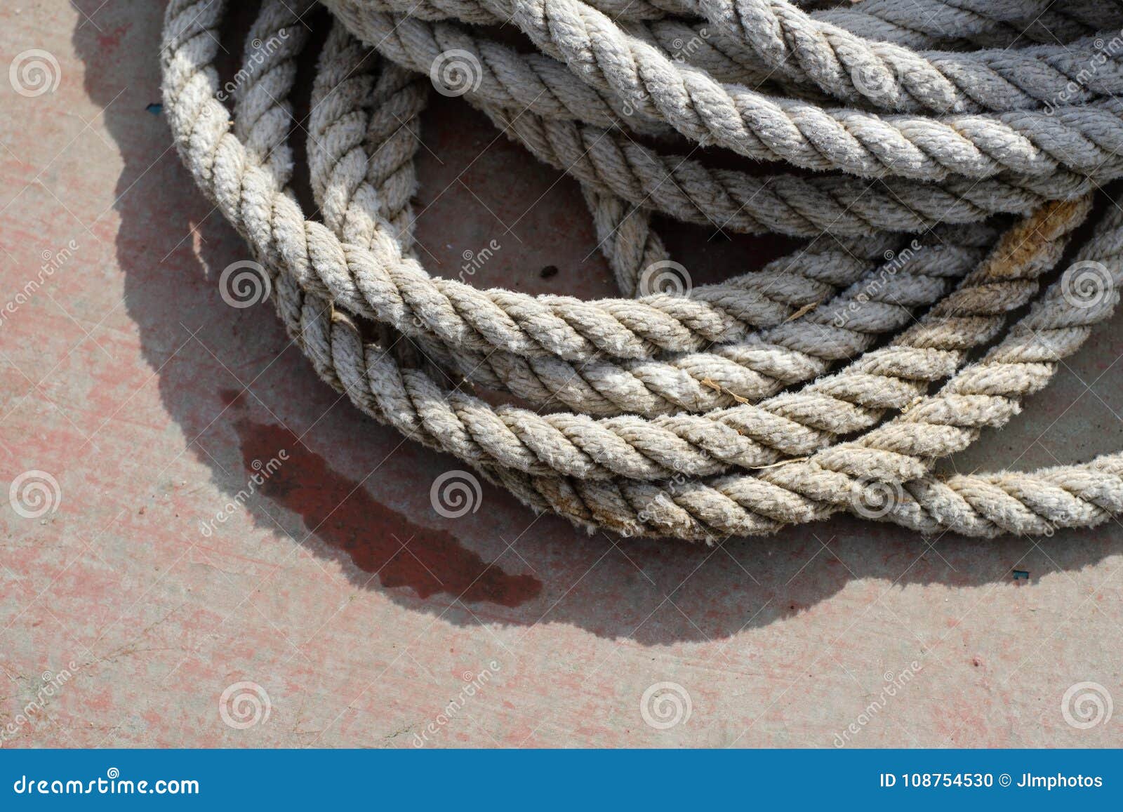 Coiled Rope Sits on a an Old Dock Stock Photo - Image of rockland ...