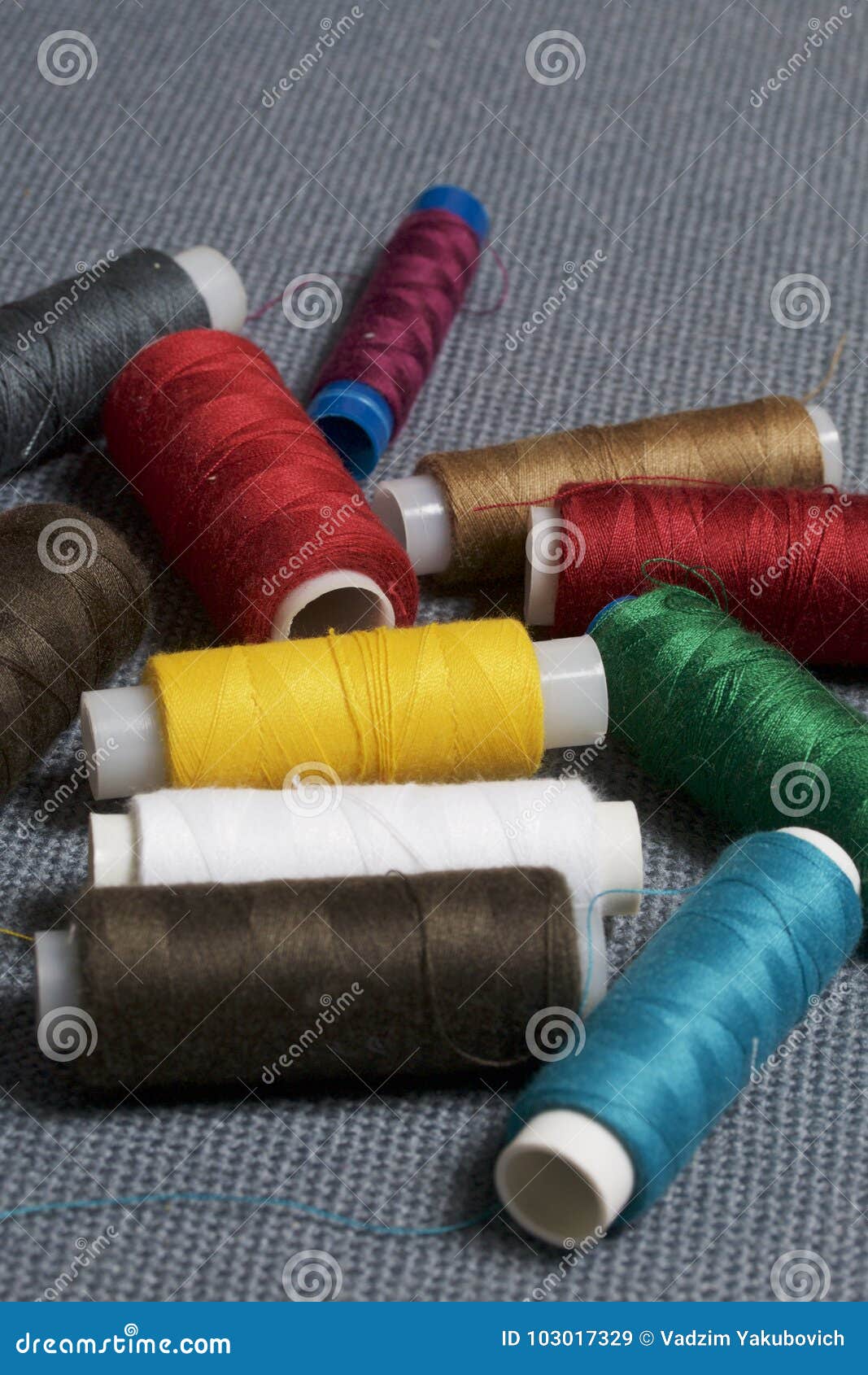 Coils of Thread of Different Colors on a Gray Woven Background Stock ...