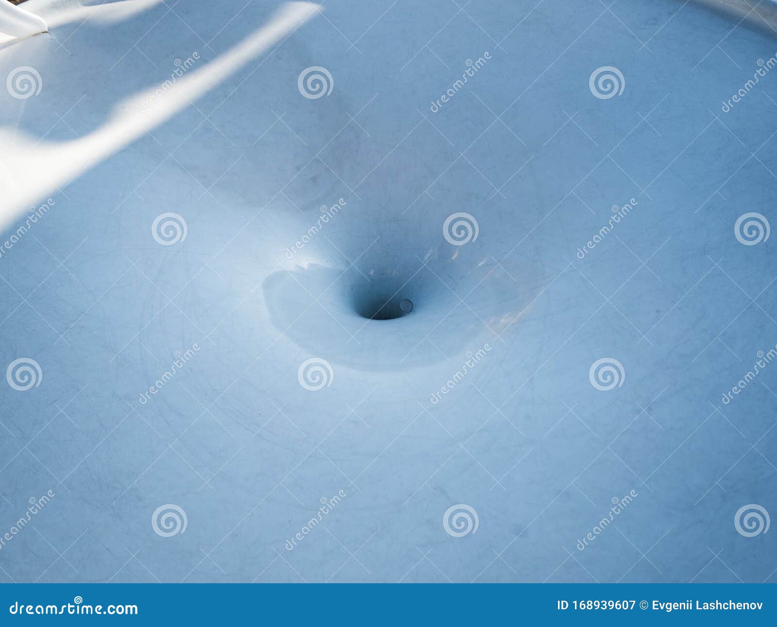 The Coin Rolls Down in a Circle on a White Surface Throwing at Luck ...