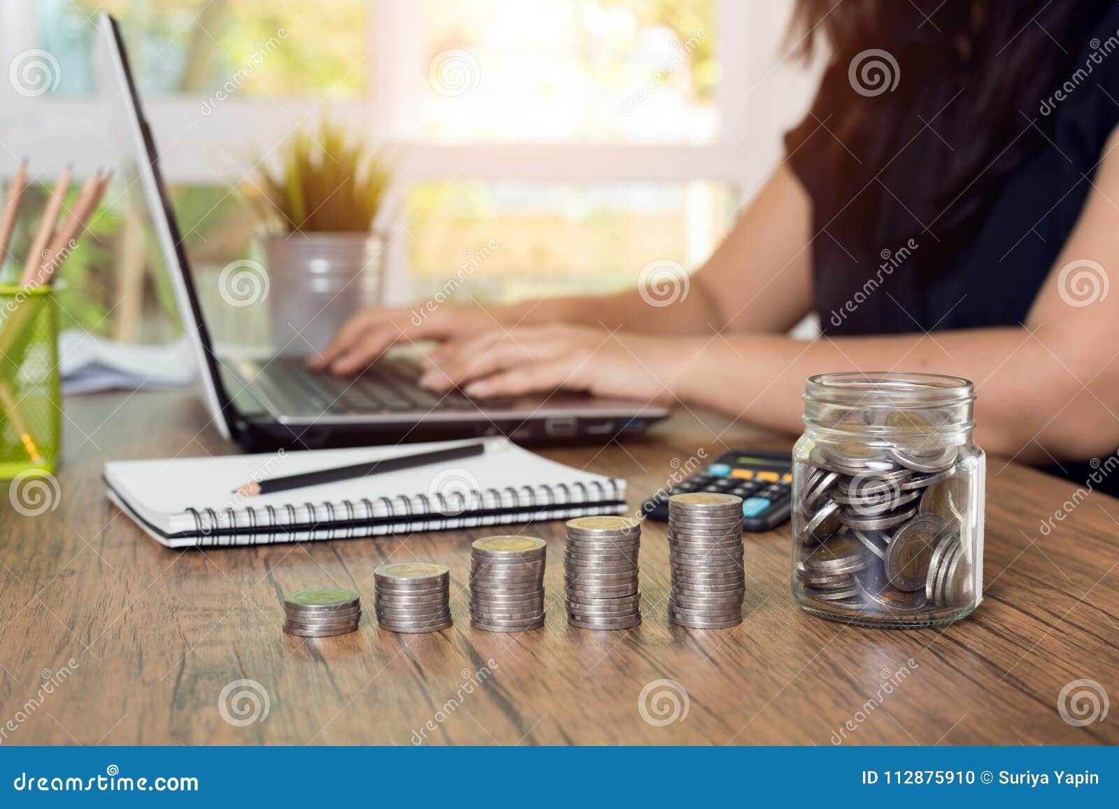 Coin Stack Step on Desk with Women Using the Computer. Stock Photo ...