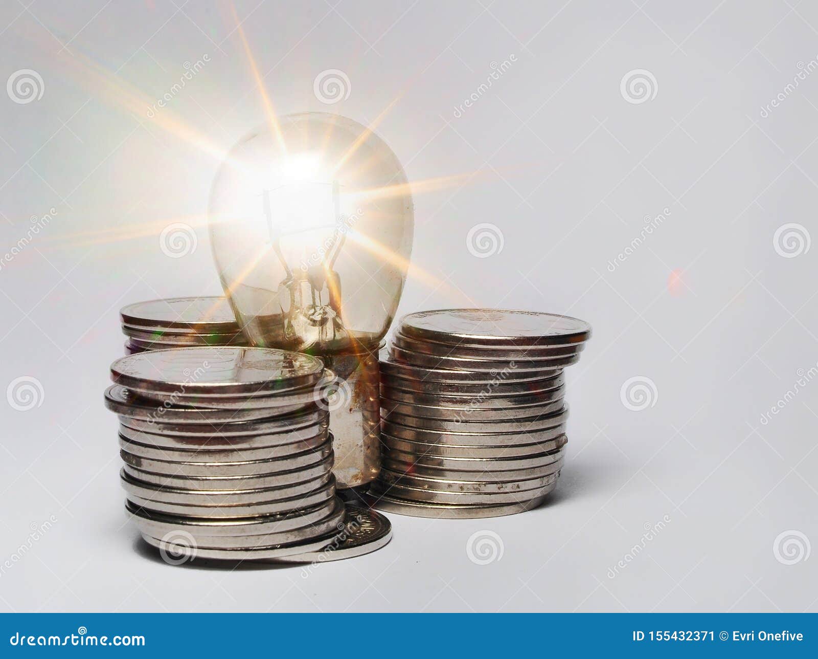 Coin stacks and light bulb stock image. Image of background - 155432371