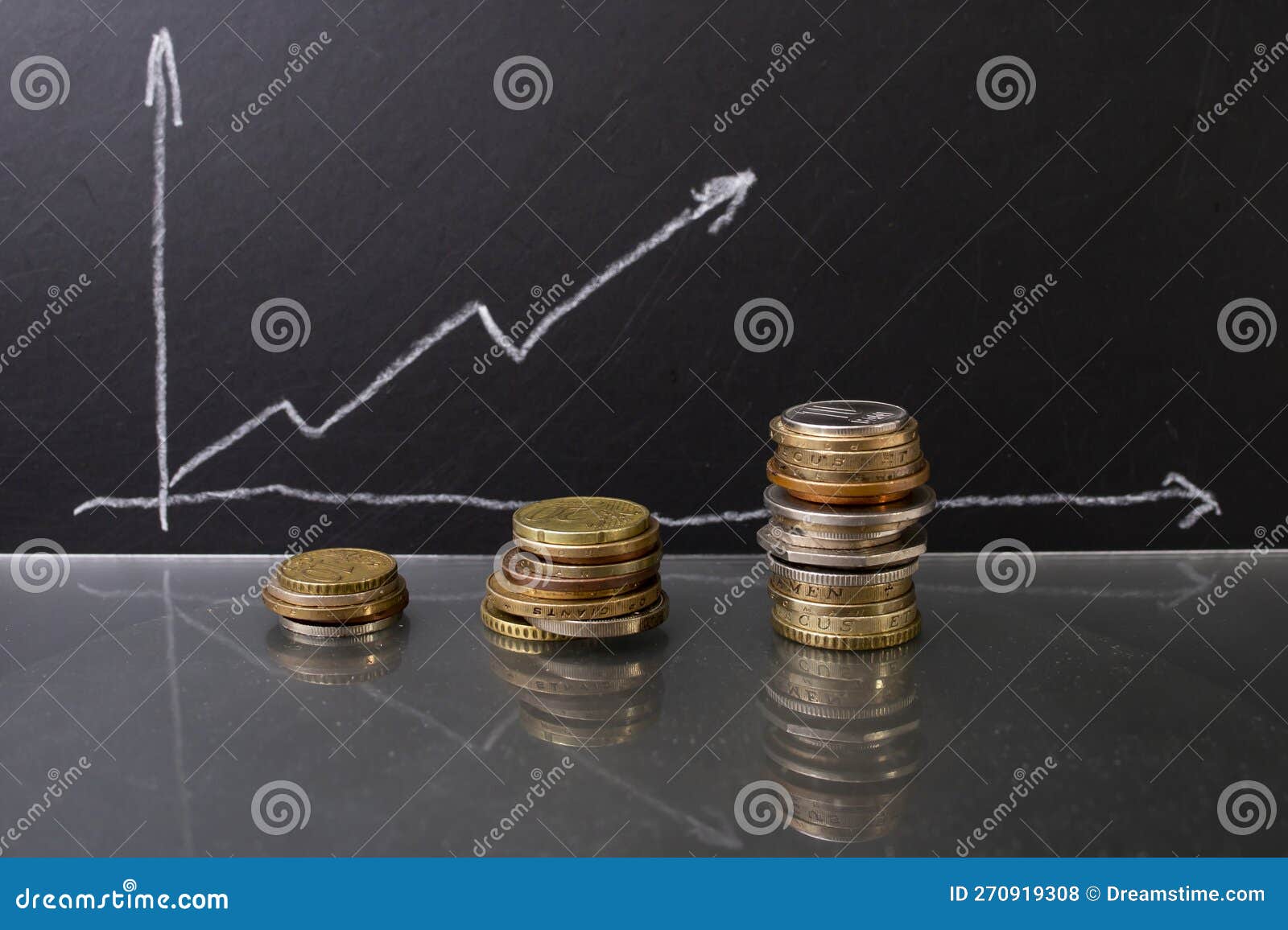 Coin Stacks Next To a Ascending Graph on a Black Chalk Board Stock ...