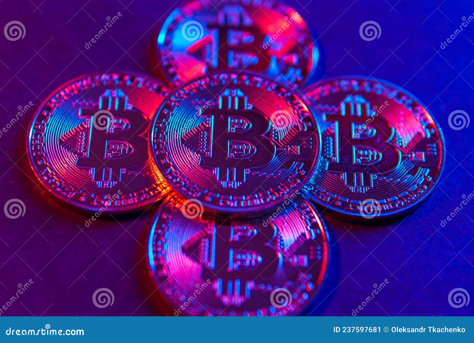 The Coins of Bitcoin are on a Dark Surface. Purple and Pink Neon Light ...