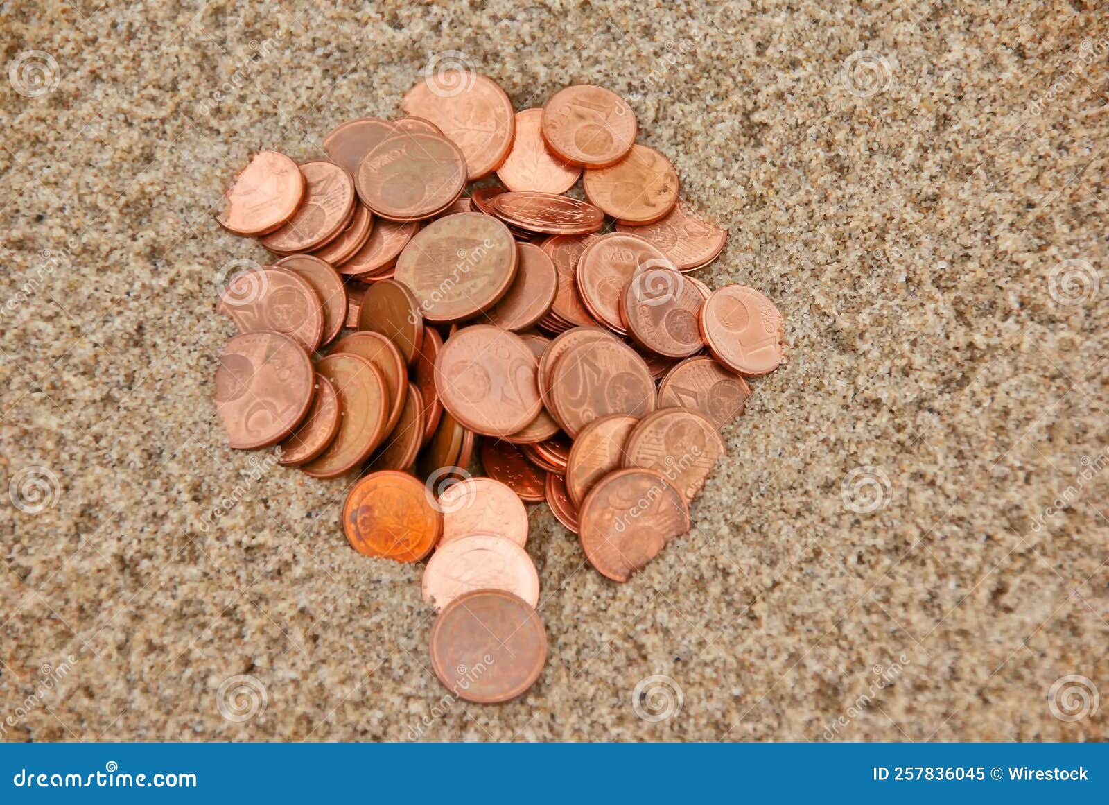 Coins buried in the sand stock image. Image of wealth - 257836045