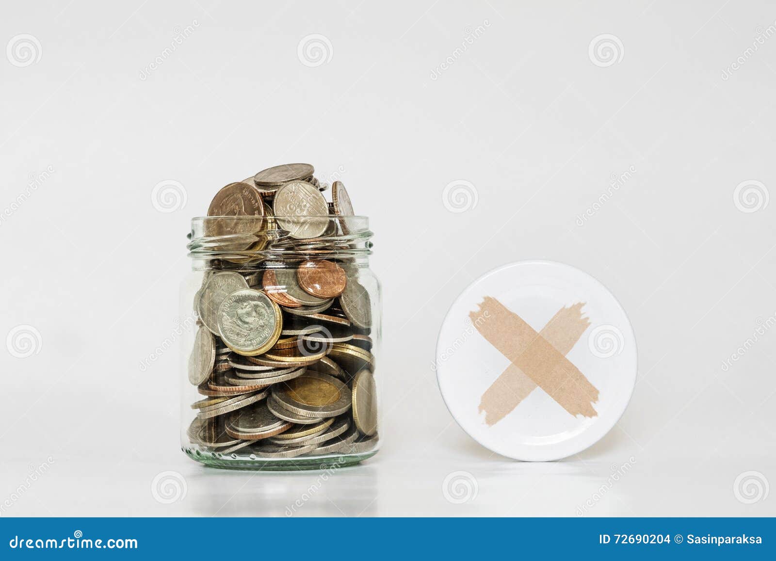 Coins in Glass Jar, and Covered with Cross Symbol Stock Photo - Image ...