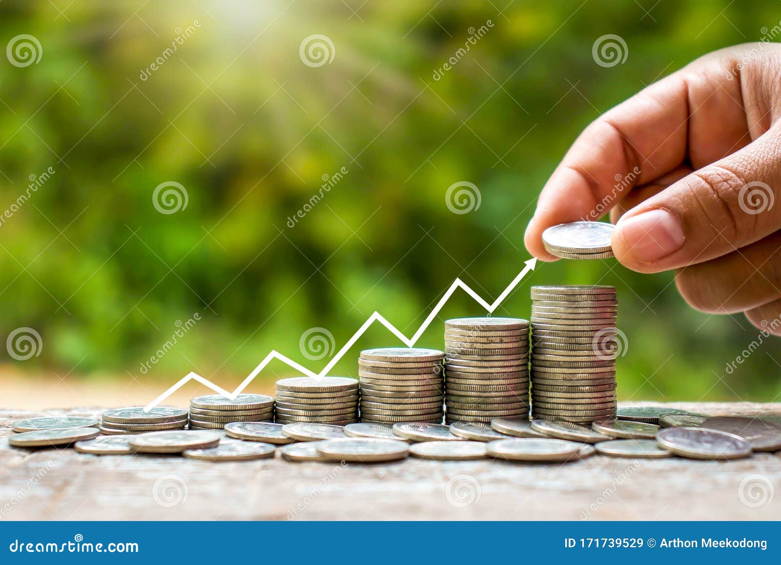 Coins and Graphs Stack Hand Holding a Coin. Stock Image - Image of ...