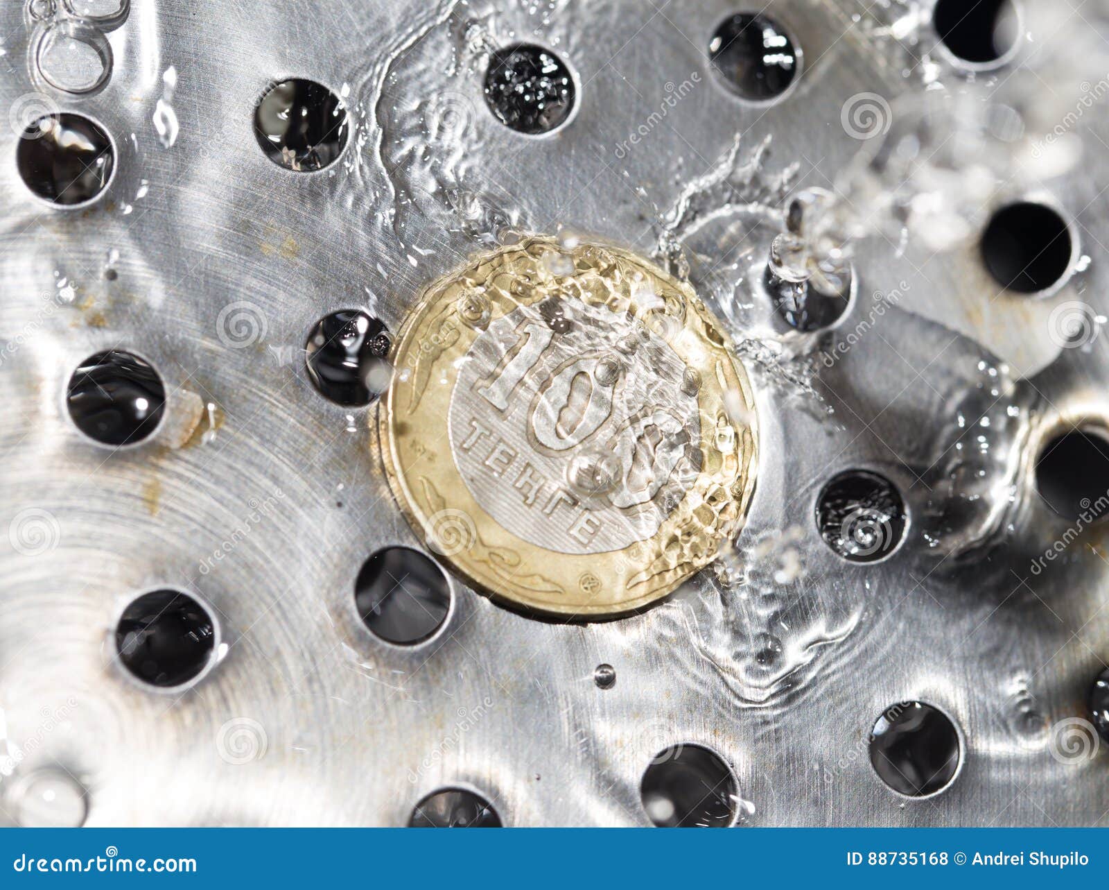 Coins in a spray of water stock photo. Image of light - 88735168
