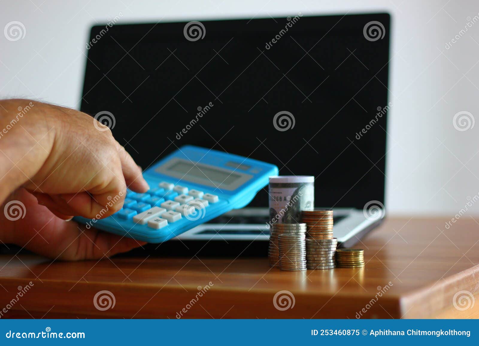 Coins Stack beside Laptop with Worker Us Calculator , Money Concept ...