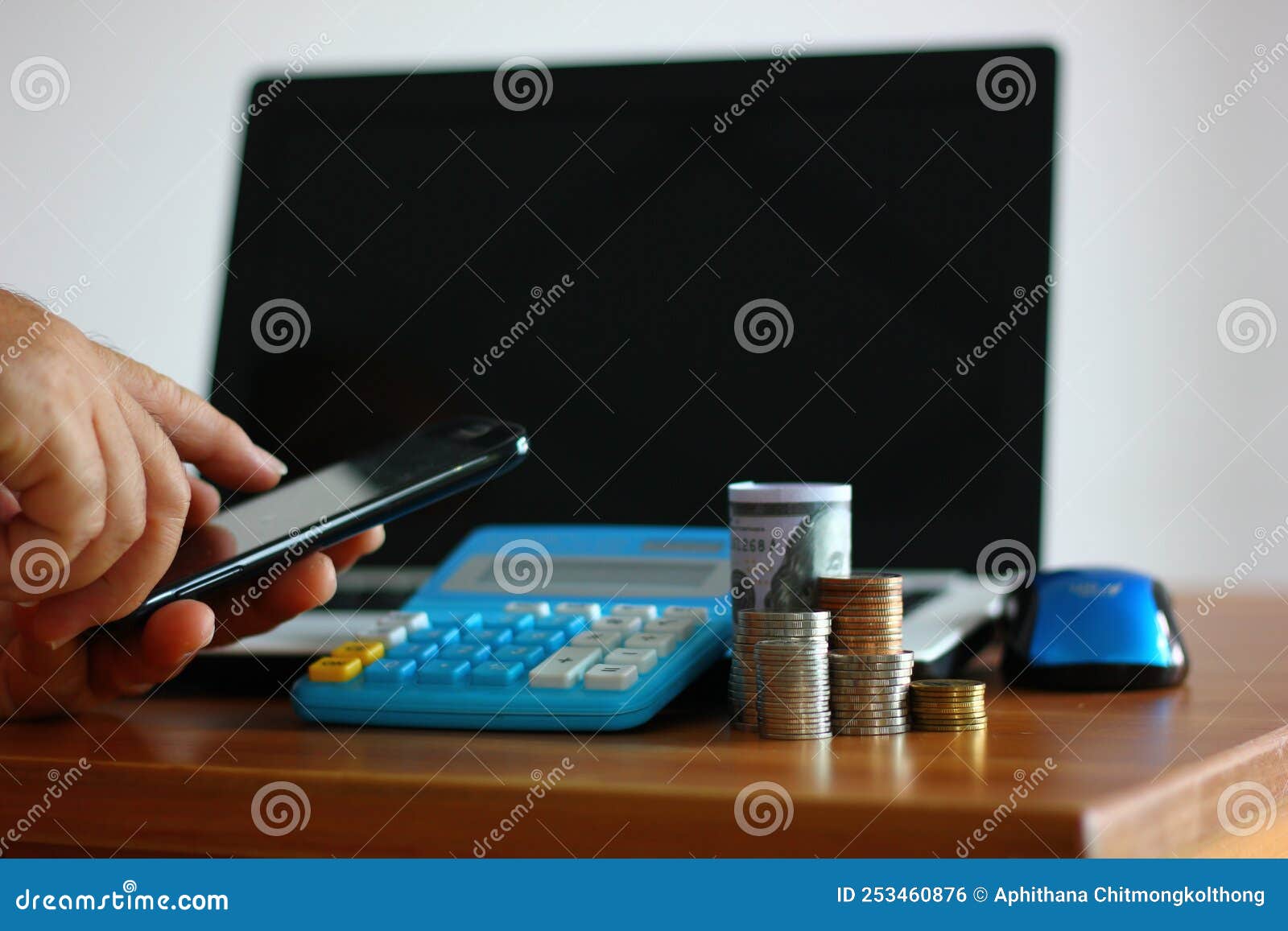 Coins Stack on Wood Table while Worker Using Mobile Phone Searching ...
