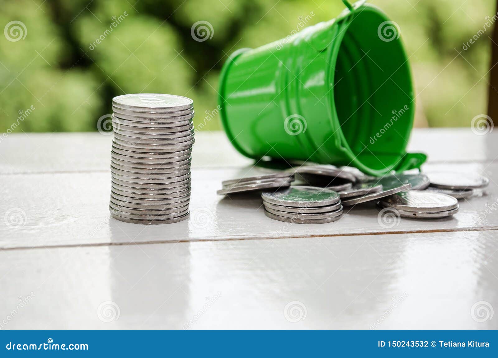 Coins and a Toy, Green Bucket on the Table. Stock Photo - Image of ...