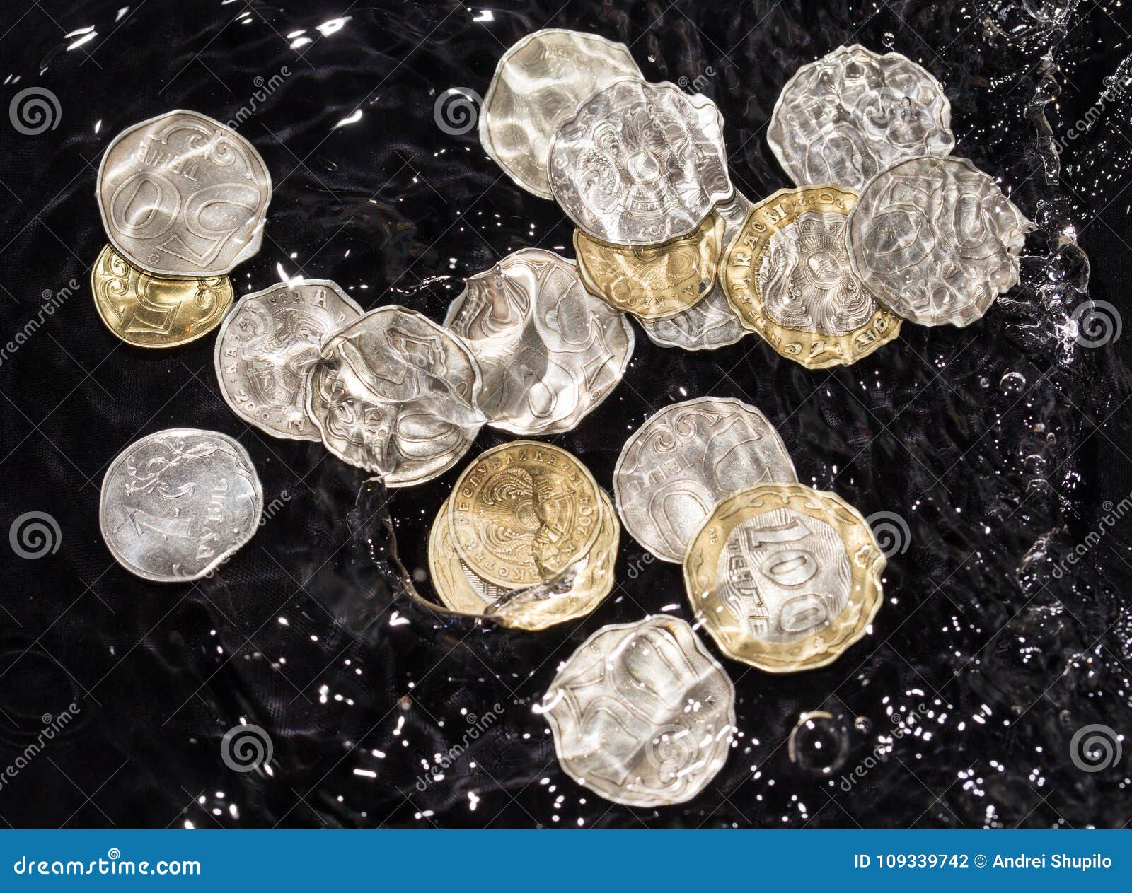 Coins in Water Splashes on a Black Background Stock Photo - Image of ...