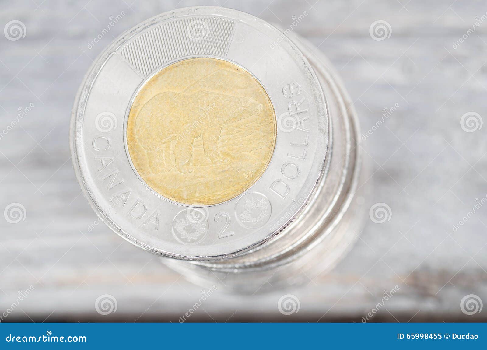 Coins on a wooden table editorial image. Image of cylinder - 65998455