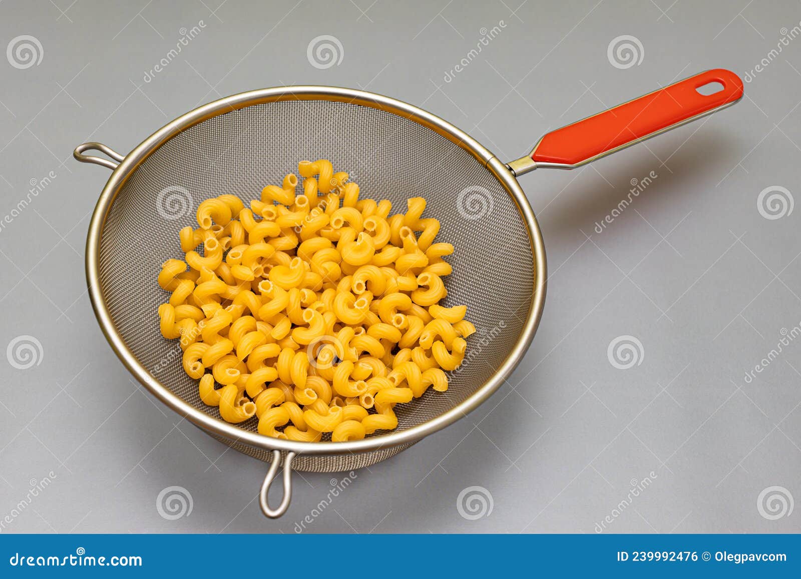 Colander with a Red Handle in Which Pasta is in the Form of a Spiral ...