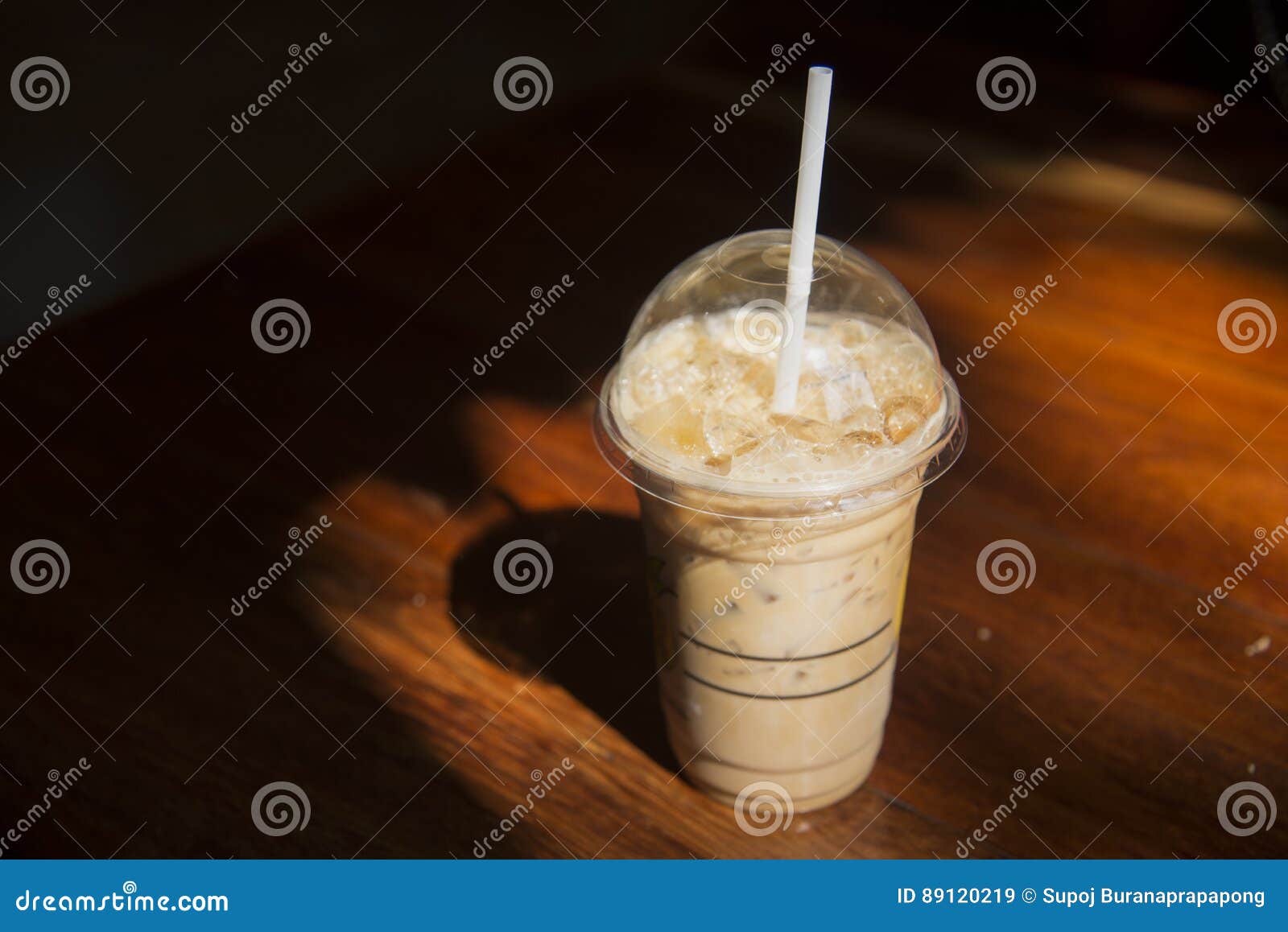 Cold Coffee in Plastic Cup on Brown Wooden Table at Cafe. Stock Image ...