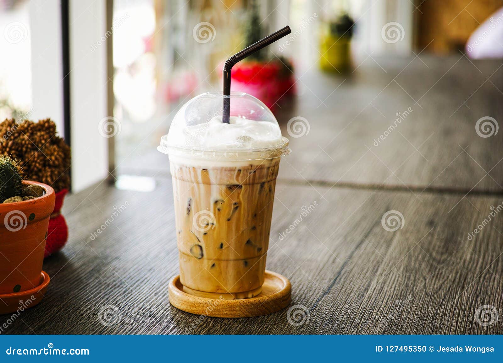 Cold Iced Coffee in Plastic Glass on Table in the Coffee Cafe Stock ...