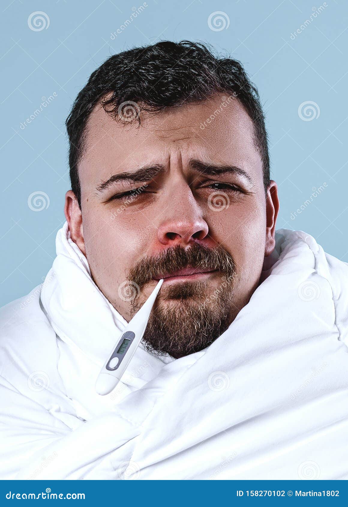 Man with Cold Sitting on Sofa with Thermometer in Mouth Stock Photo ...