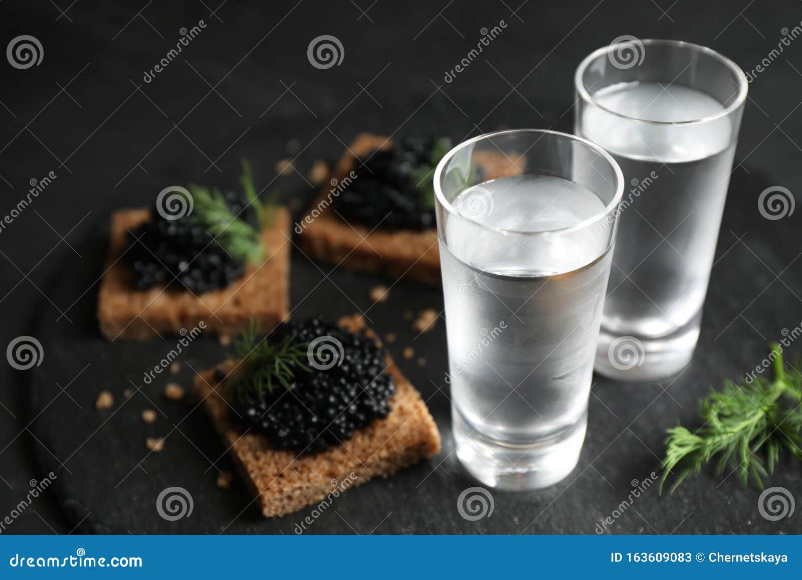 Cold Russian Vodka and Sandwiches with Black Caviar on Table Stock ...