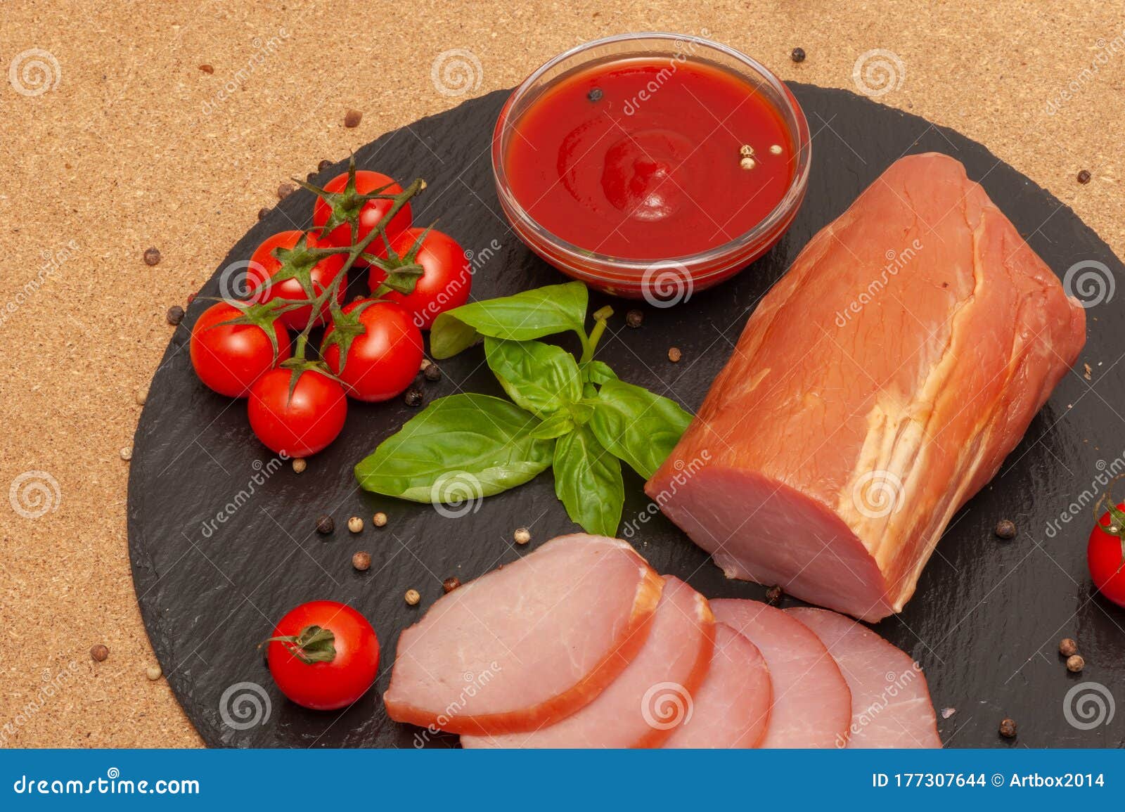 Cold Smoked Meat with Sauce, Cherry Tomatoes and Basil on a Black ...