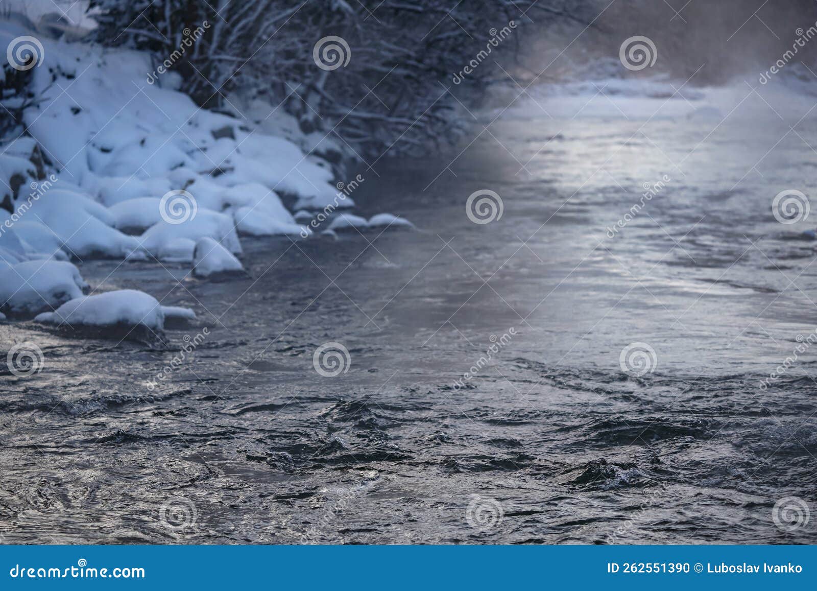 Cold Winter River, Steam Visible Above Water, Dark Trees on Both Sides ...