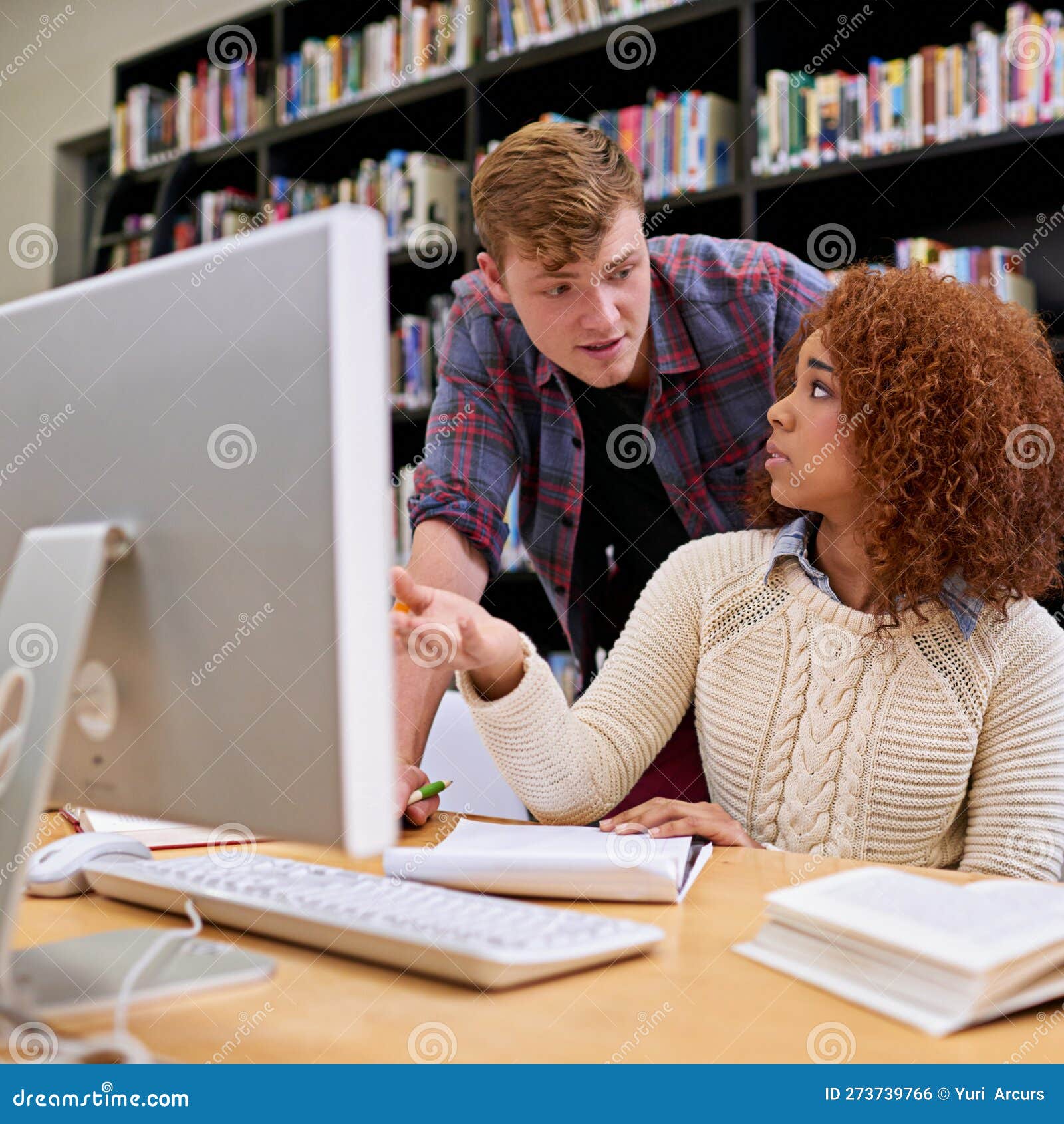 Collaborating on an Assignment. Two Students Working Together at a ...