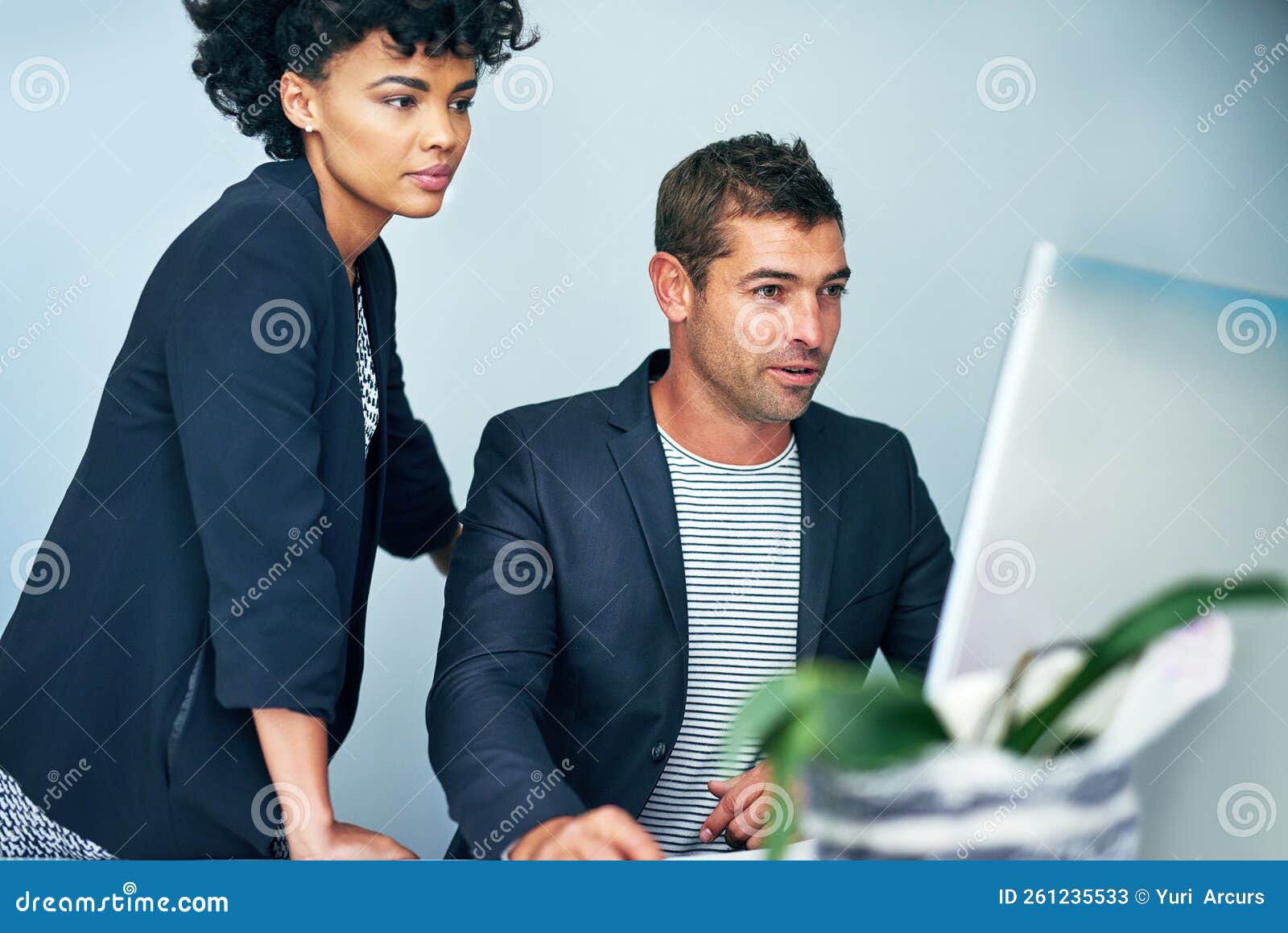 Collaborating on Problem Solving. Two Coworkers Working Together at a ...