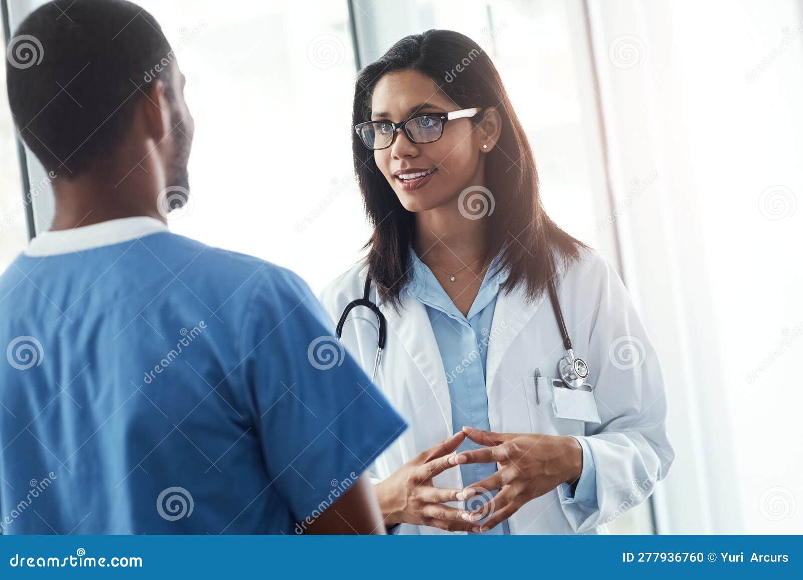 Collaborations that Save Lives. Two Young Doctors Having a Discussion ...