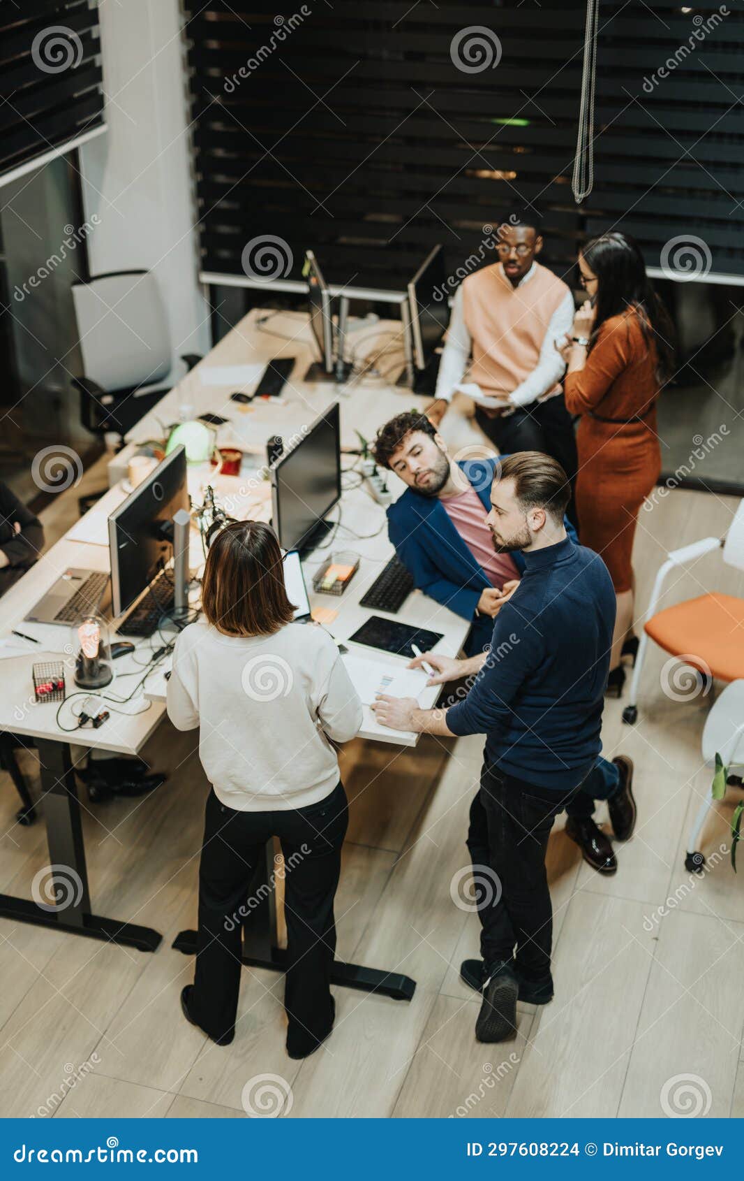Multiracial Colleagues Collaborating on a Late-night Project in a ...