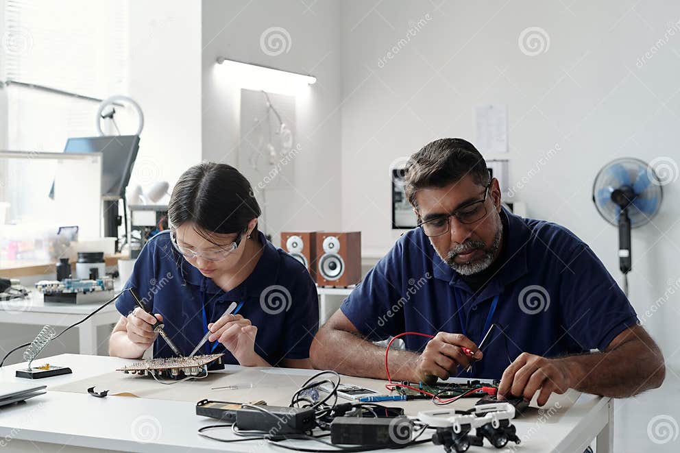 Collaborative Engineers Working on Circuit Boards in Lab Stock Photo ...